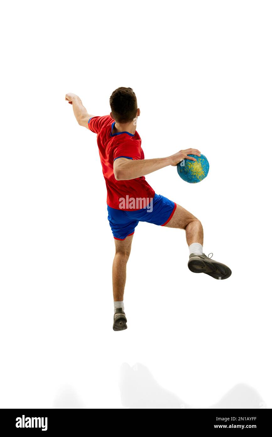 Back view. Dynamic studio shot of professional male handball player in ...