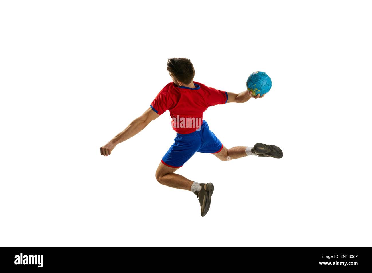 Goal. Back view studio shot of young man, professional handball player ...
