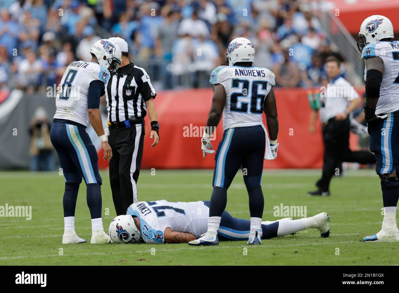 Tennessee Titans tackle Taylor Lewan (77) lies on the field after being ...