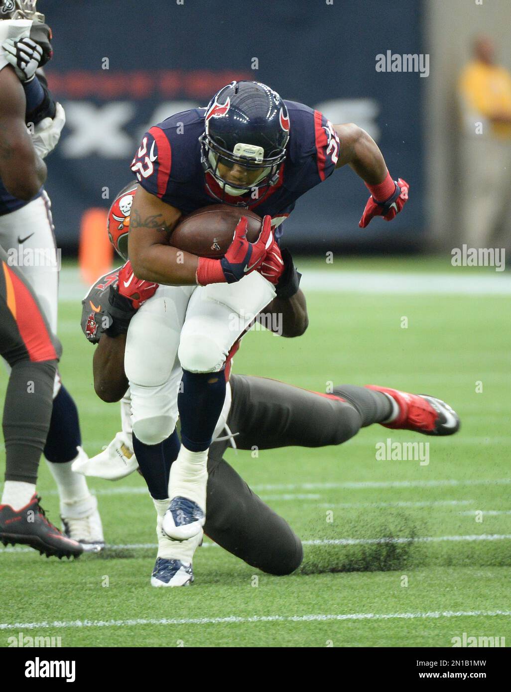 Houston Texans running back Chris Polk (22) is tackled by Tampa Bay ...
