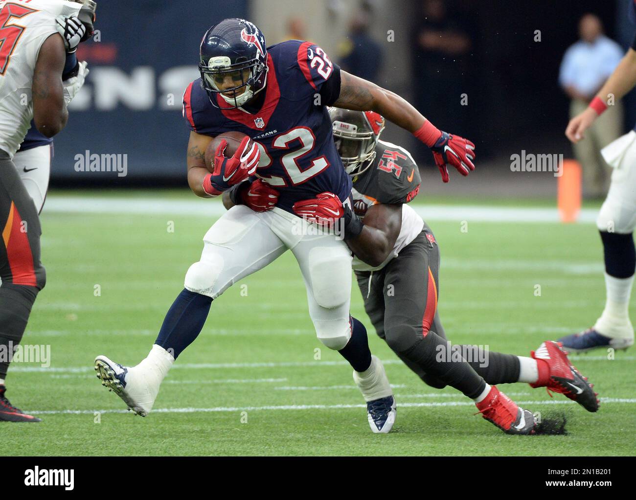 Houston Texans' Chris Polk (22) is pulled down by Tampa Bay Buccaneers ...