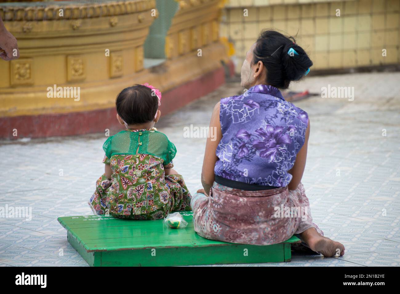 Child and woman with face paint mask sitting and praying in Botahtaung Paya (Buddha's First ...