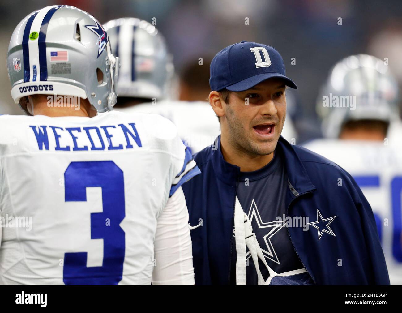 Dallas Cowboys' Brandon Weeden (3) and Tony Romo, right, stand on field ...