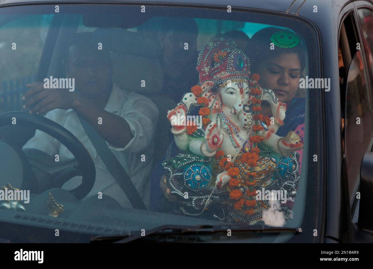Indian Hindu devotees carry an idol of the elephant-headed Hindu god ...