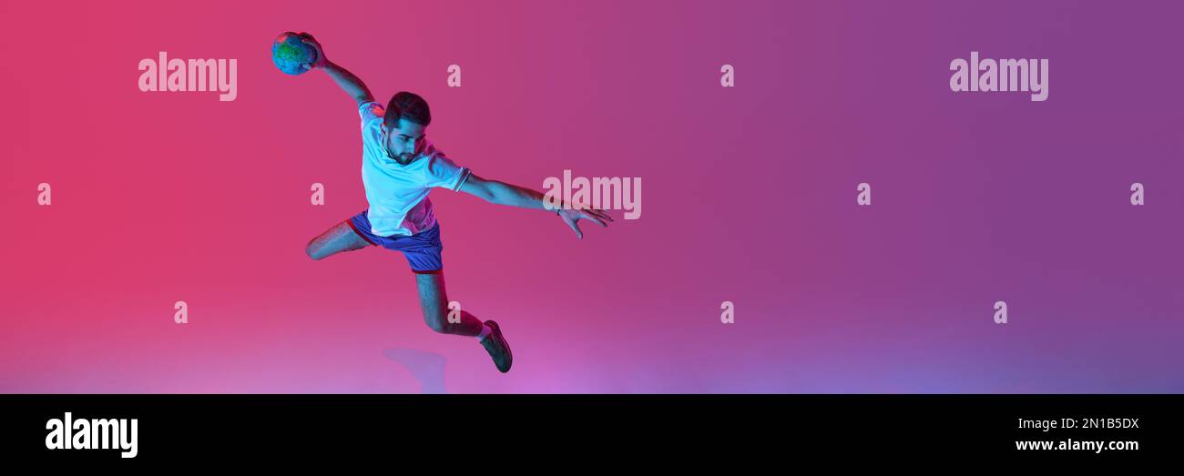 Aerial view. Young man, professional handball player playing isolated ...