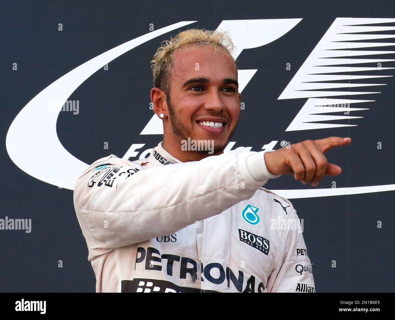 Mercedes driver Lewis Hamilton of Britain celebrates on the podium ...