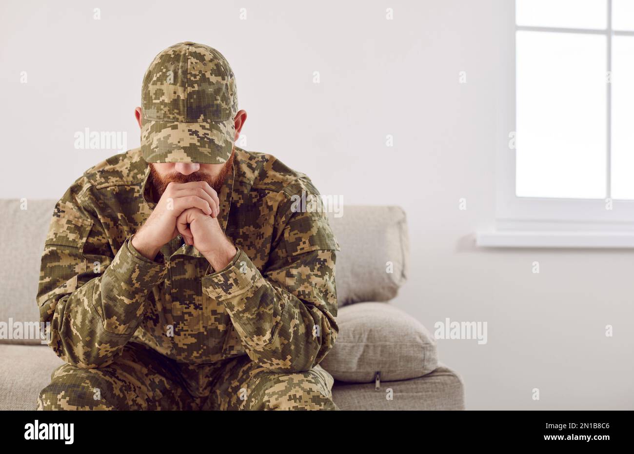 Serious anxious and nervous military man suffers from depression while ...
