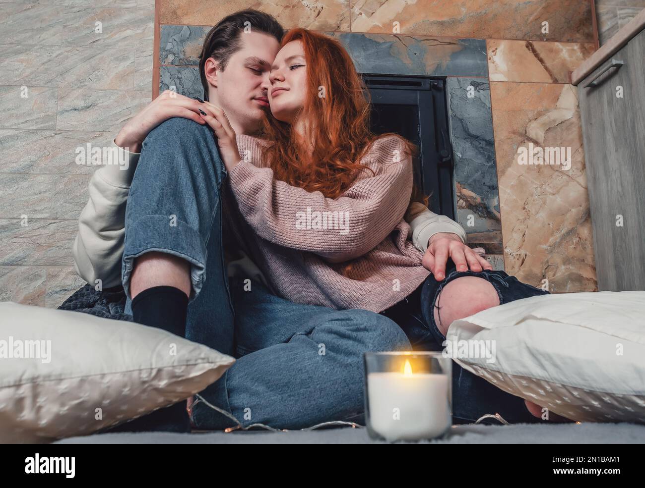 Romantic gentle hugs of lovers in cozy room. Modern design, candles ...