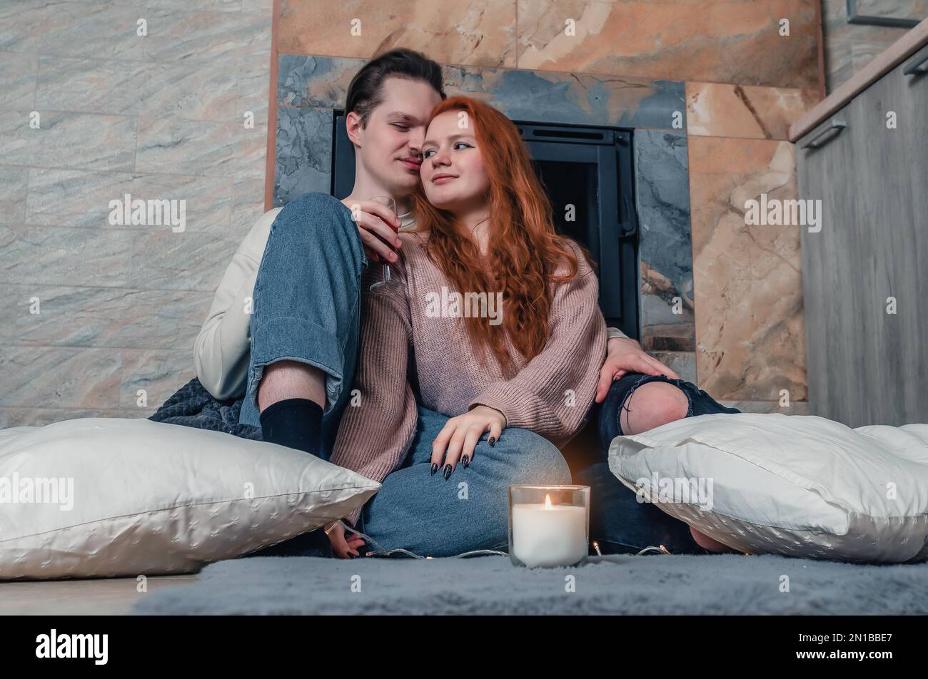 Romantic gentle hugs of lovers in cozy room. Modern design, candles ...