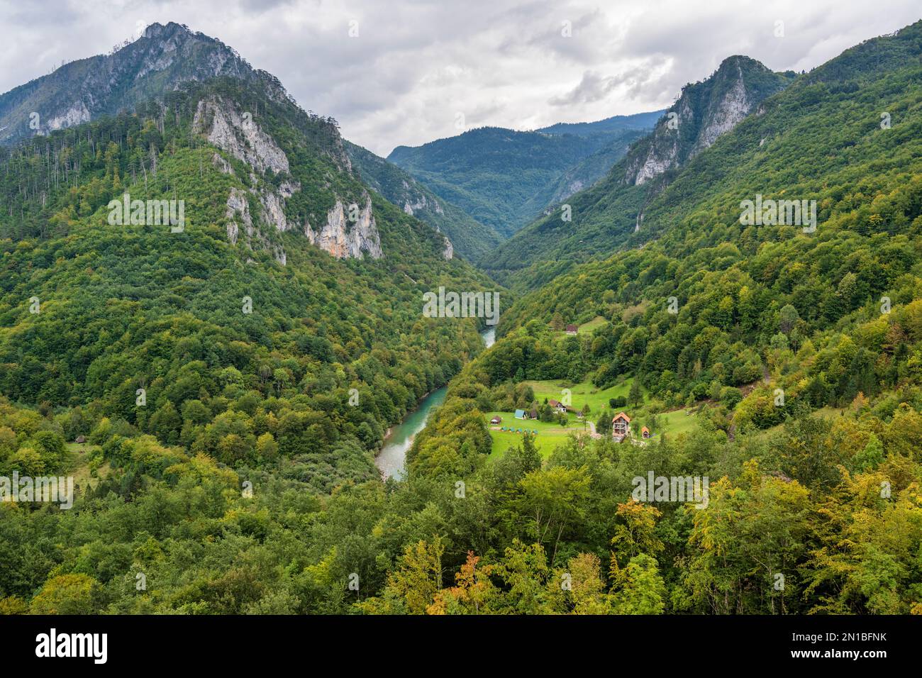 Lush green countryside and towering peaks in the Tara River valley in ...