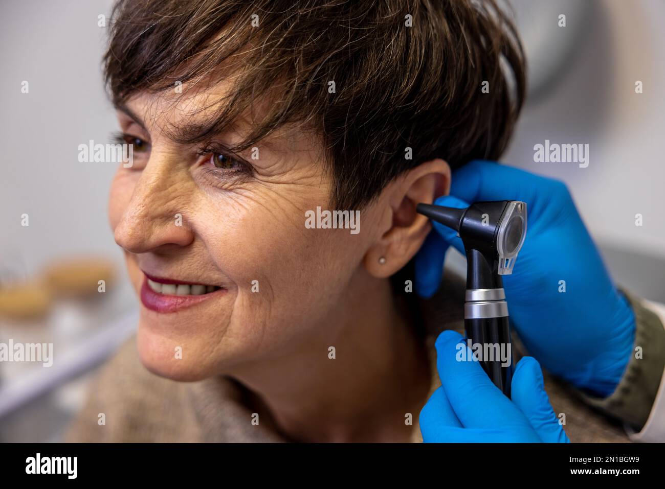 ENT doctor examining an elderly female patient Stock Photo - Alamy