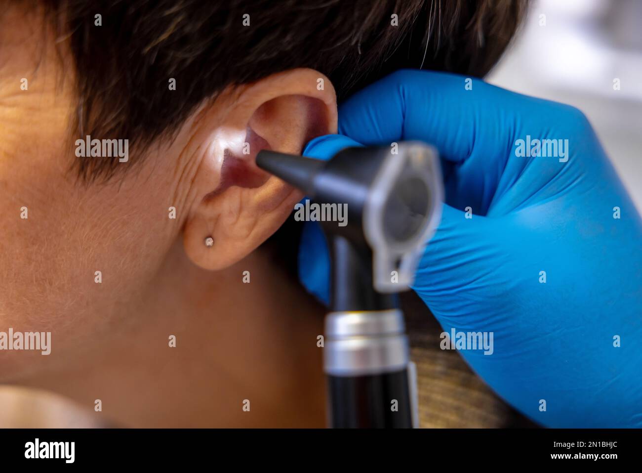 ENT doctor examining an elderly female patient Stock Photo - Alamy