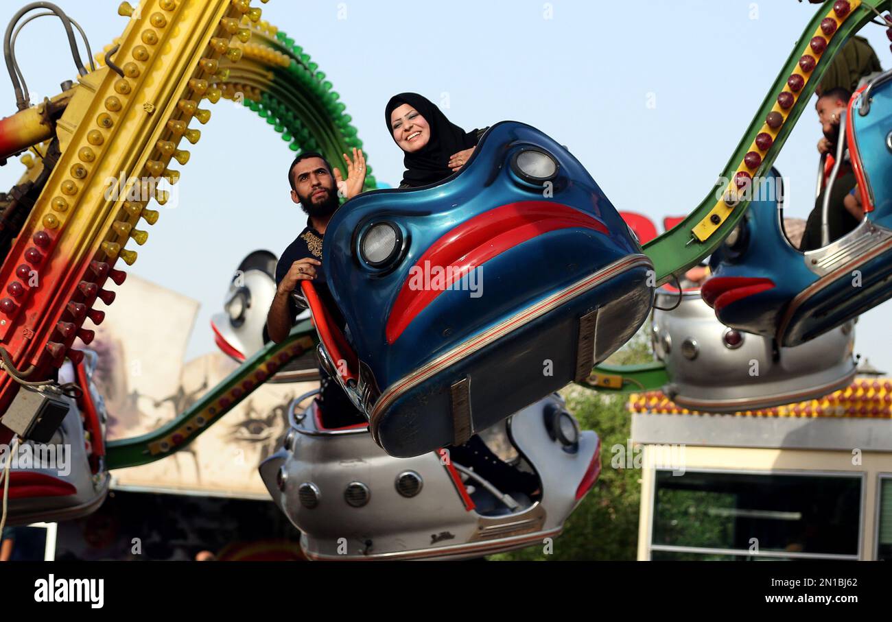 Iraqis enjoy a ride at Amusement City fairgrounds during Eid al-Adha ...