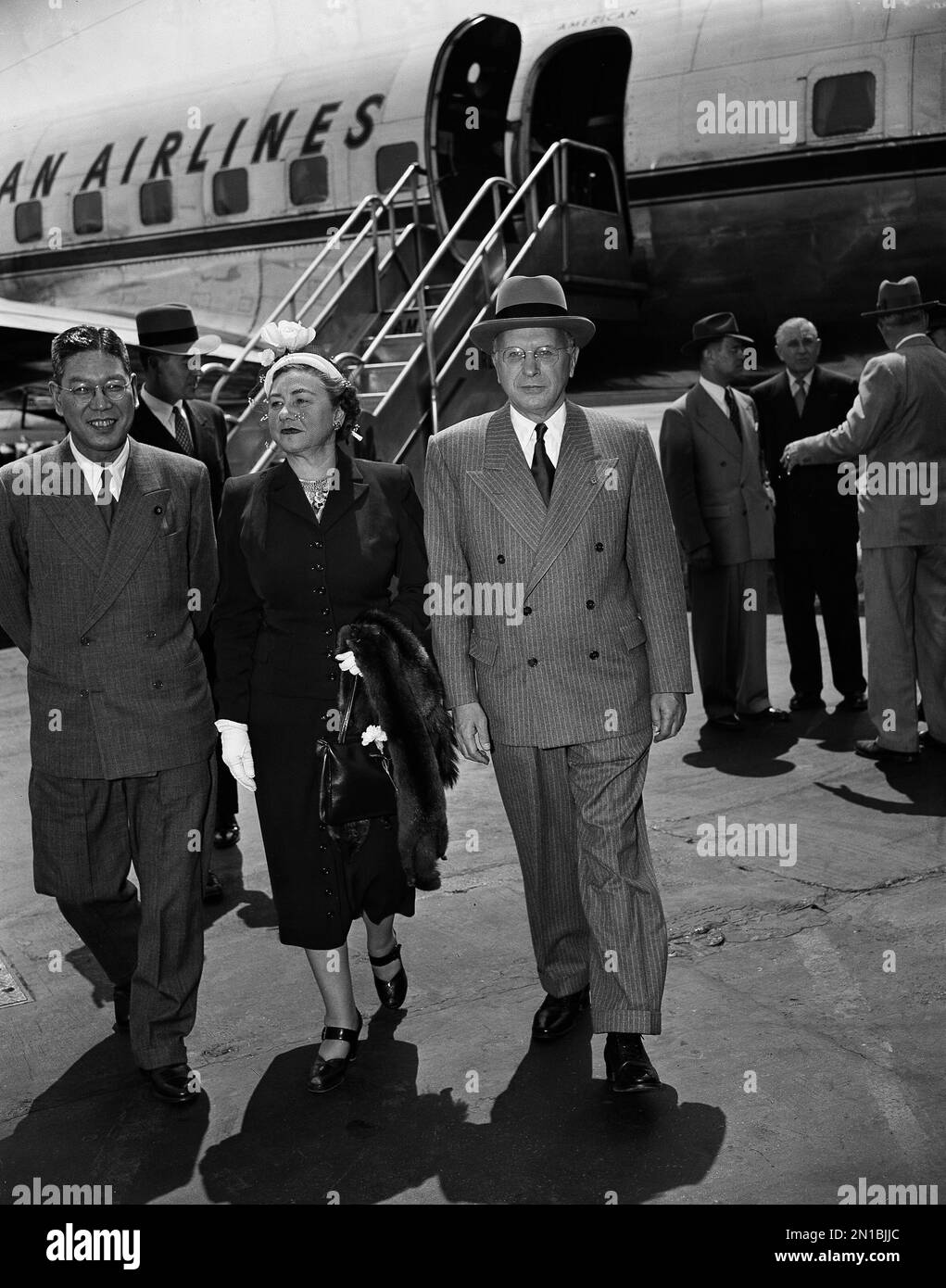 Hayato Ikeda, left, Japanese finance minister, walks from his plane ...
