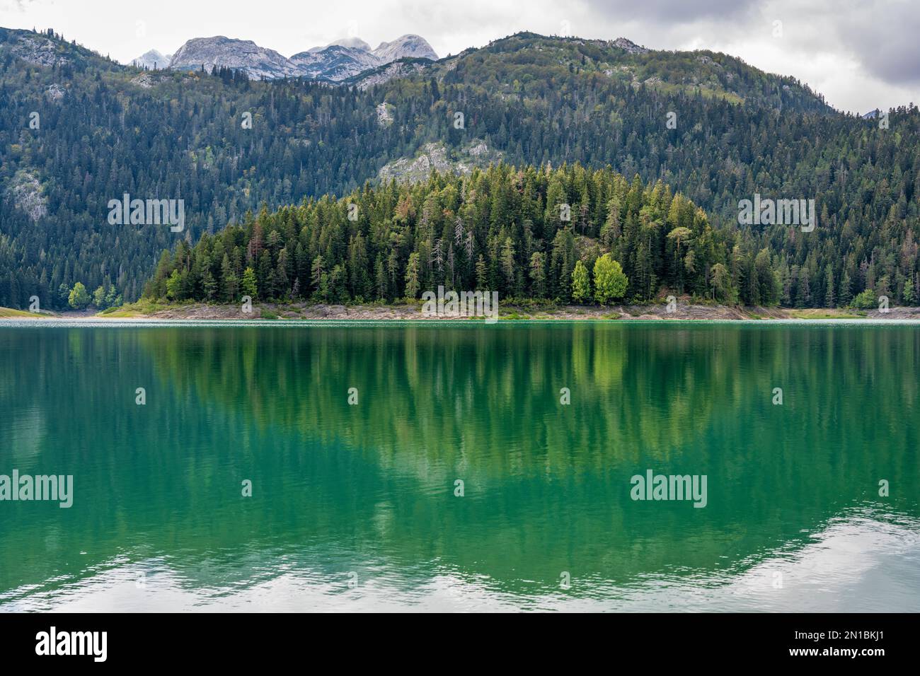 Reflections in the still glacial waters of The Black Lake (Crno Jezero ...