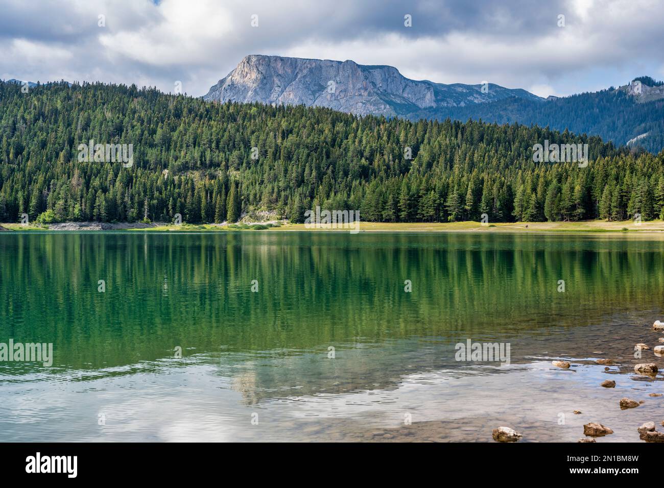 Reflections in the still glacial waters of The Black Lake (Crno Jezero ...