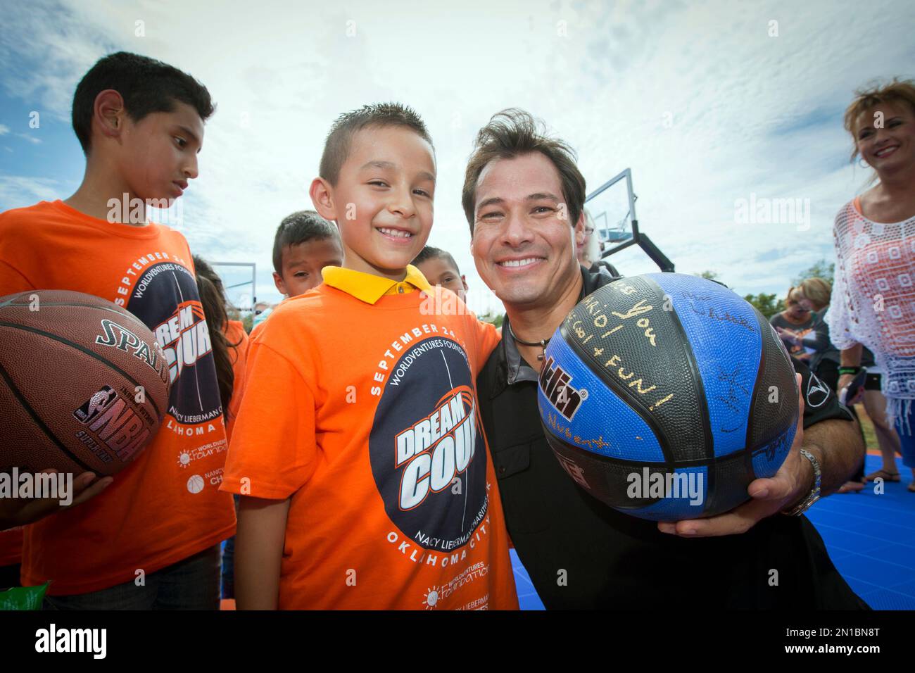 Wayne Nugent, founder of WorldVentures, signs a basketball during the ...