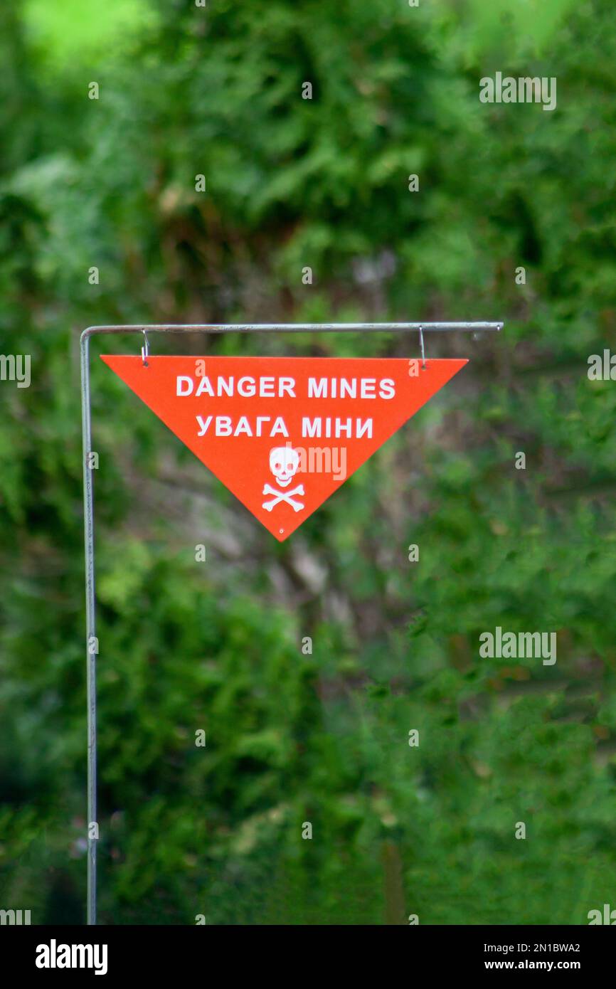 Danger mines. Sapper minefield warning sign on green background. Jolly ...