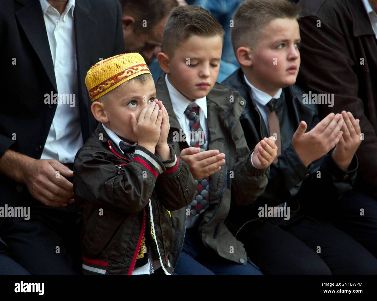 Kosovo Muslim boys offer prayers outside Sultan Mehmet Fatih grand mosque marking the Eid al ...