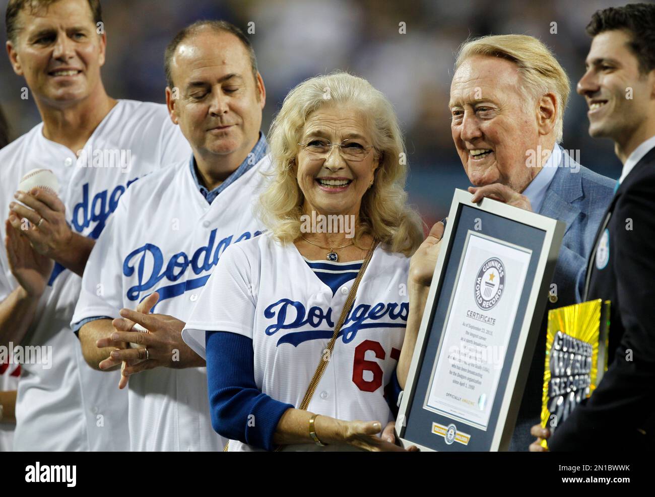 Los Angeles Dodgers broadcaster Vin Scully, second from right, is ...