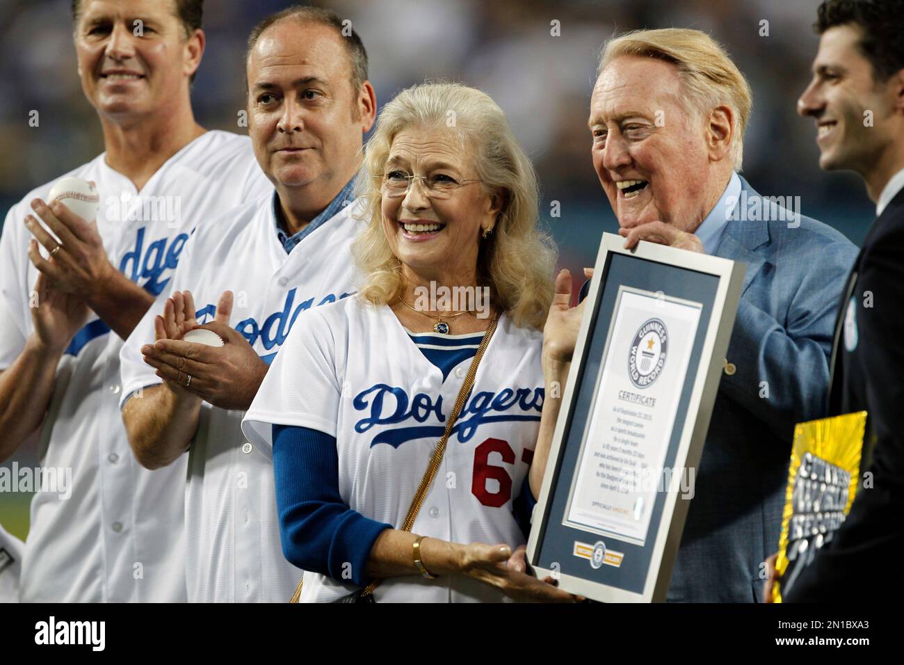 Los Angeles Dodgers broadcaster Vin Scully, second from right, is ...