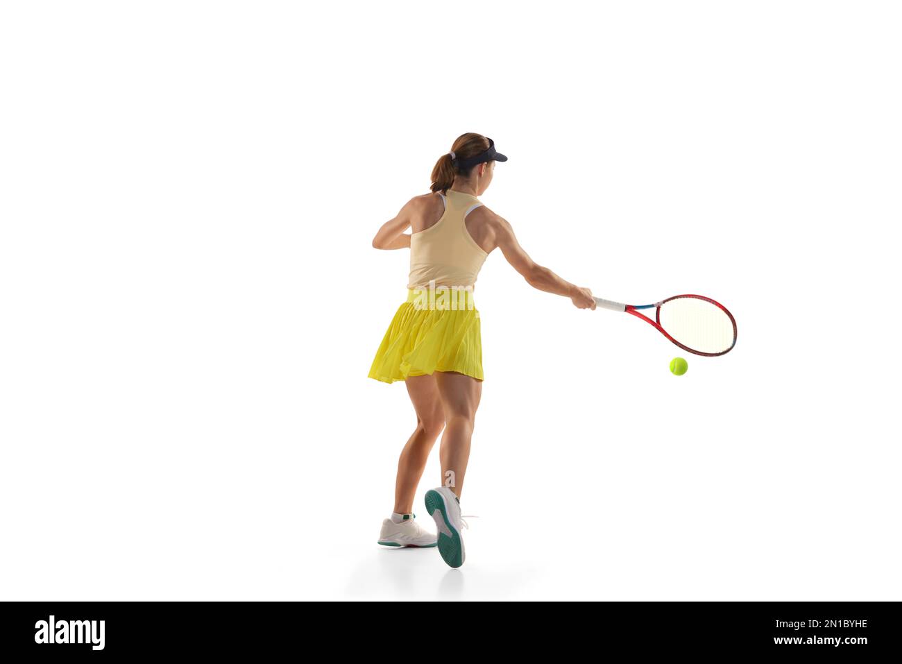 Dynamic portrait of young teen girl, tennis player in sports uniform in ...