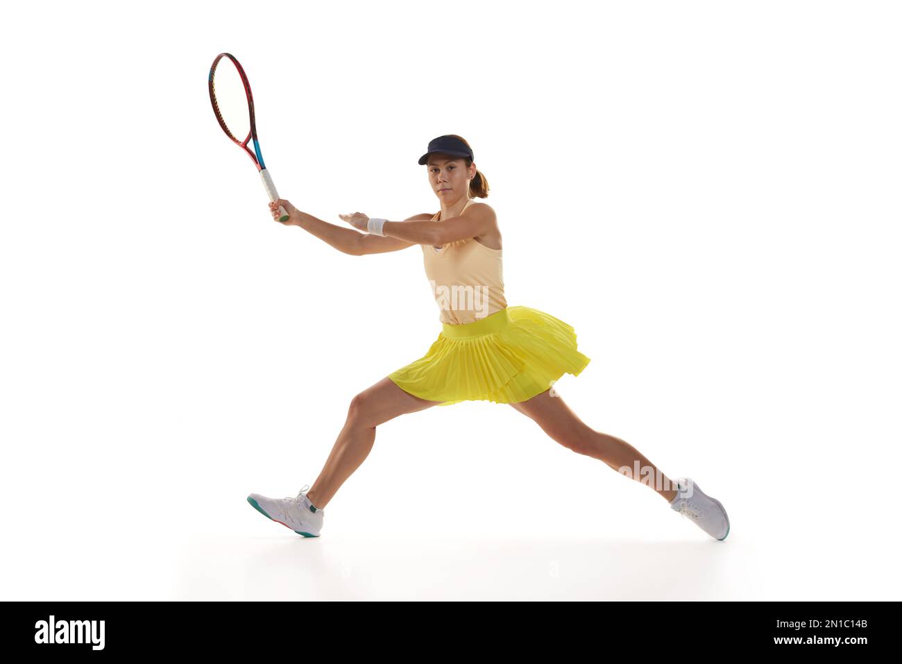 Dynamic portrait of young teen girl, tennis player in sports uniform in ...