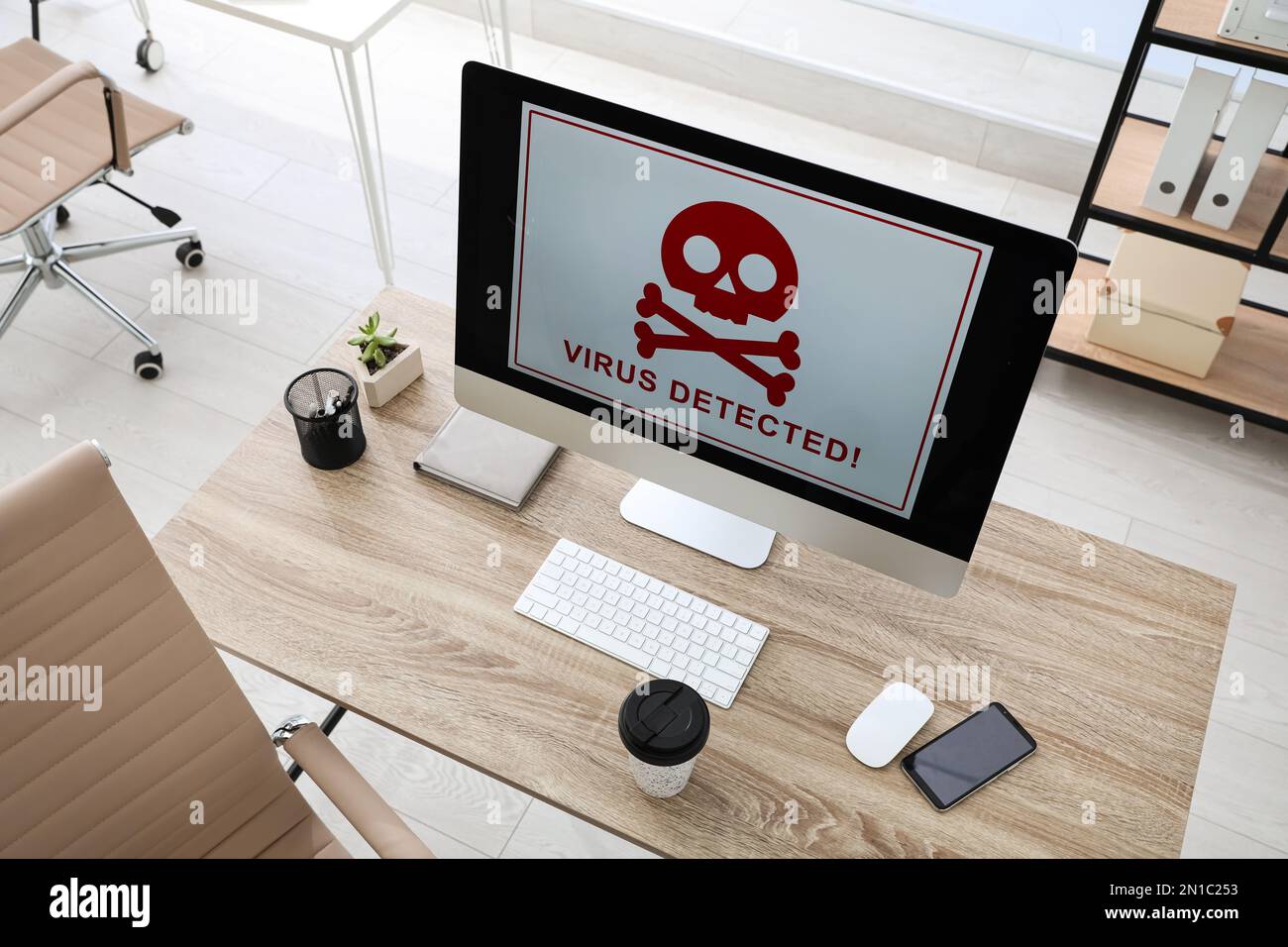 Computer with warning about virus attack on screen in office Stock ...