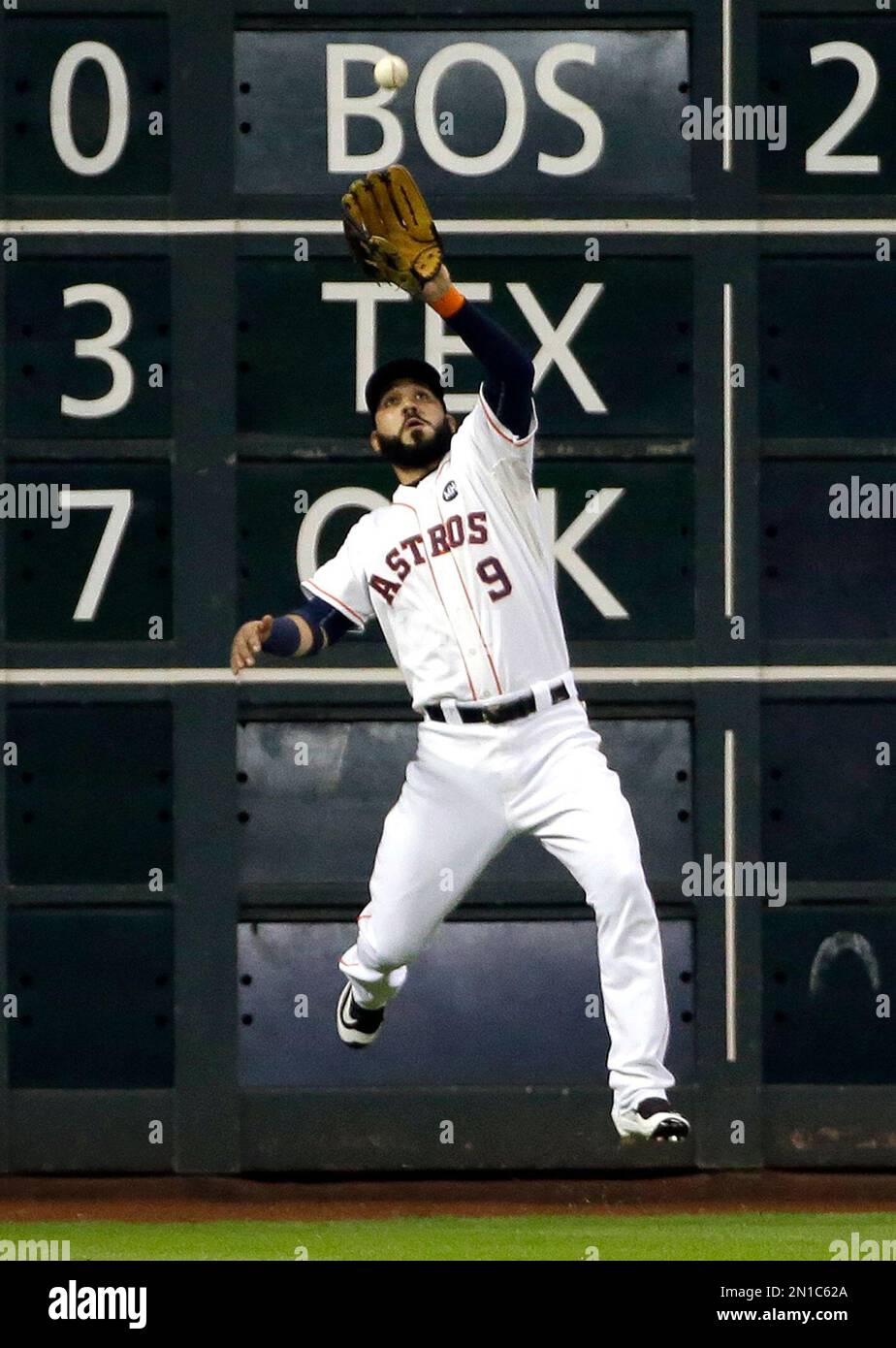 Houston Astros left fielder Marwin Gonzalez jumps and makes the catch ...