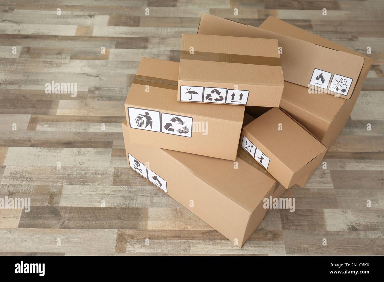 Cardboard boxes with different packaging symbols on floor. Parcel ...