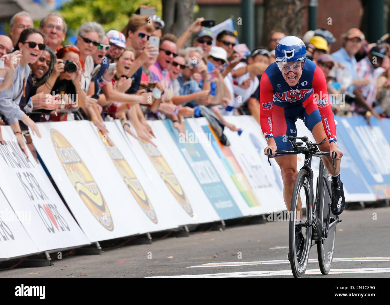 Kristin Armstrong, of the United States, is cheered by the crowd as she ...