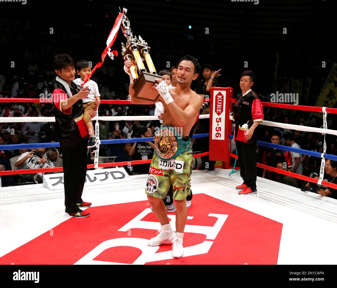 Japanese champion Shinsuke Yamanaka holding the winner's trophy poses ...