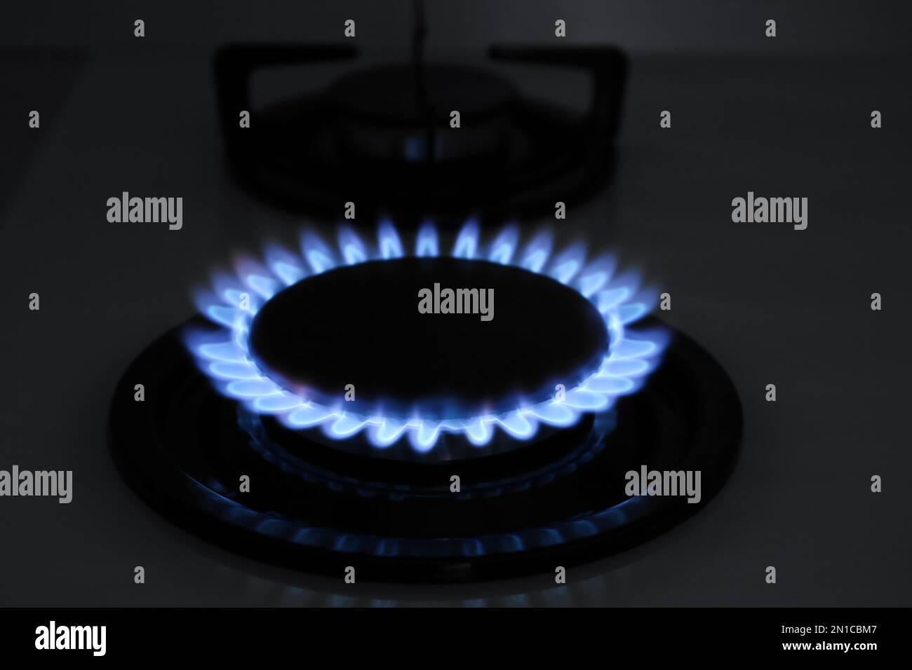 Modern gas cooktop with burning blue flame in kitchen at night Stock ...