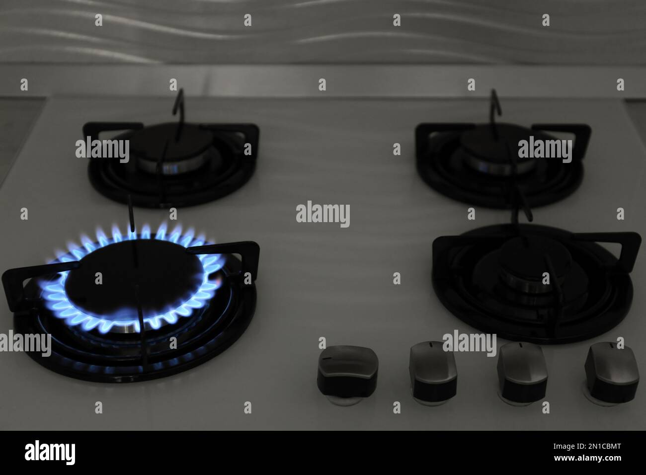 Modern gas cooktop with burning blue flames in kitchen Stock Photo - Alamy