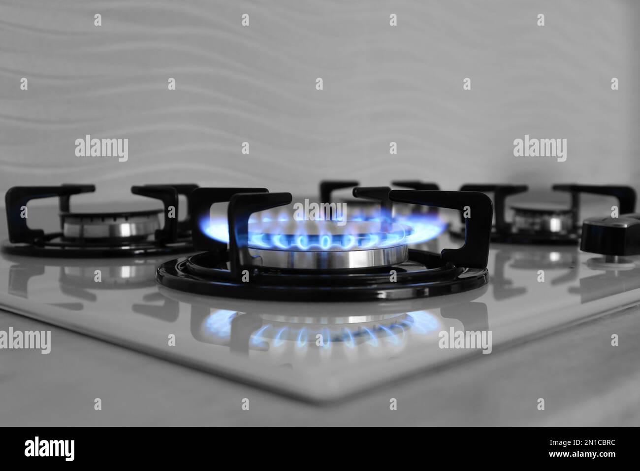 Modern gas cooktop with burning blue flame in kitchen Stock Photo - Alamy