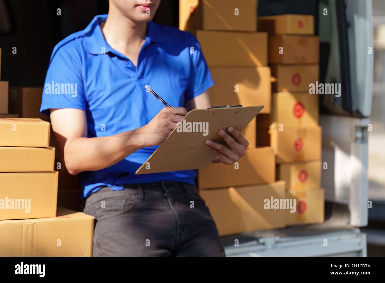 Asian courier with parcel and delivery logistic concept. Delivery man ...