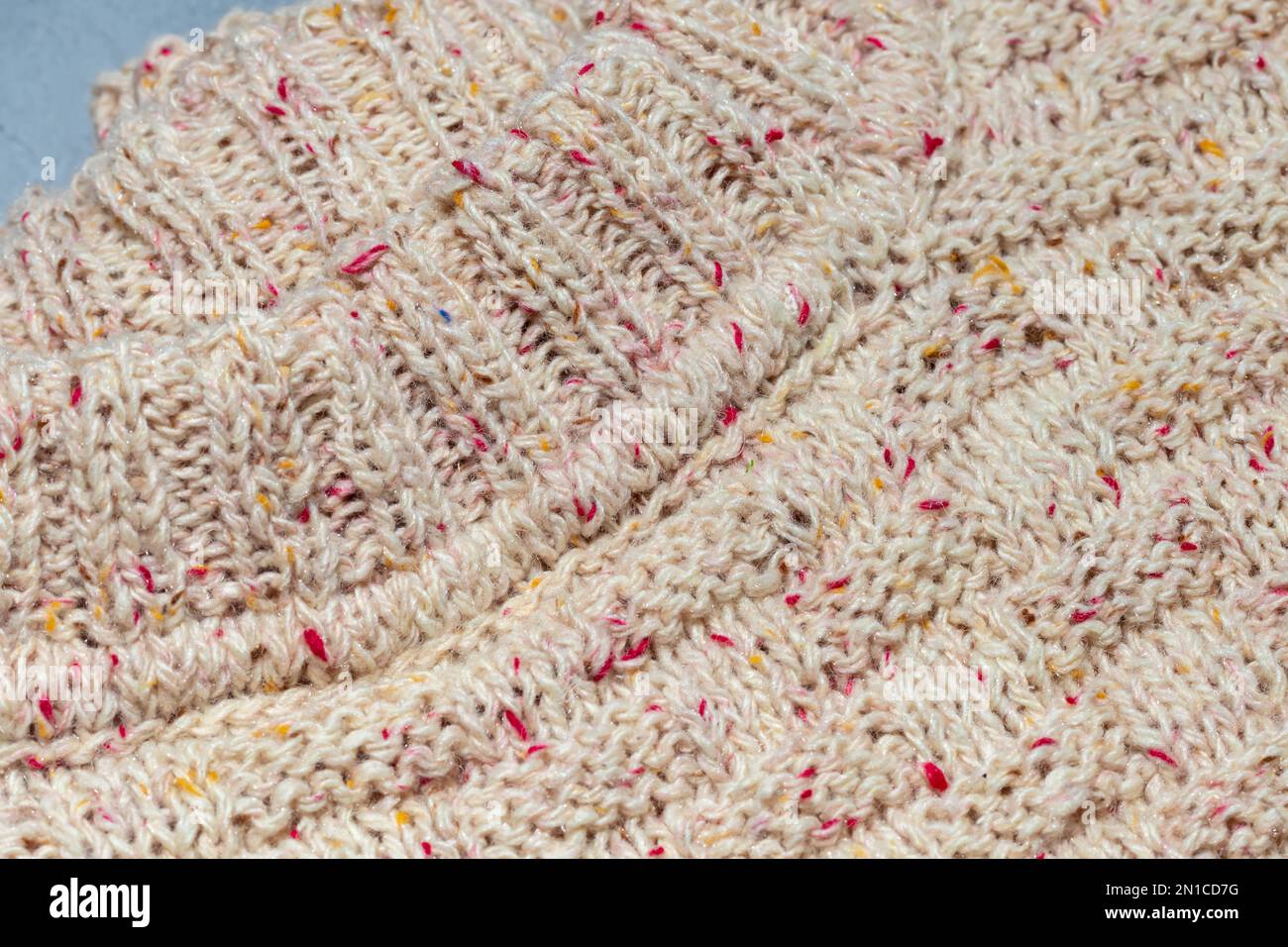 Knitted handmade items. Knitted fabric from colored thread. Bright ...