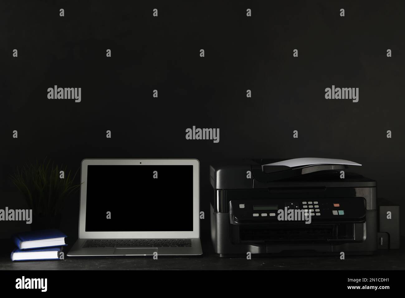 New modern printer, laptop and office supplies on black table Stock ...
