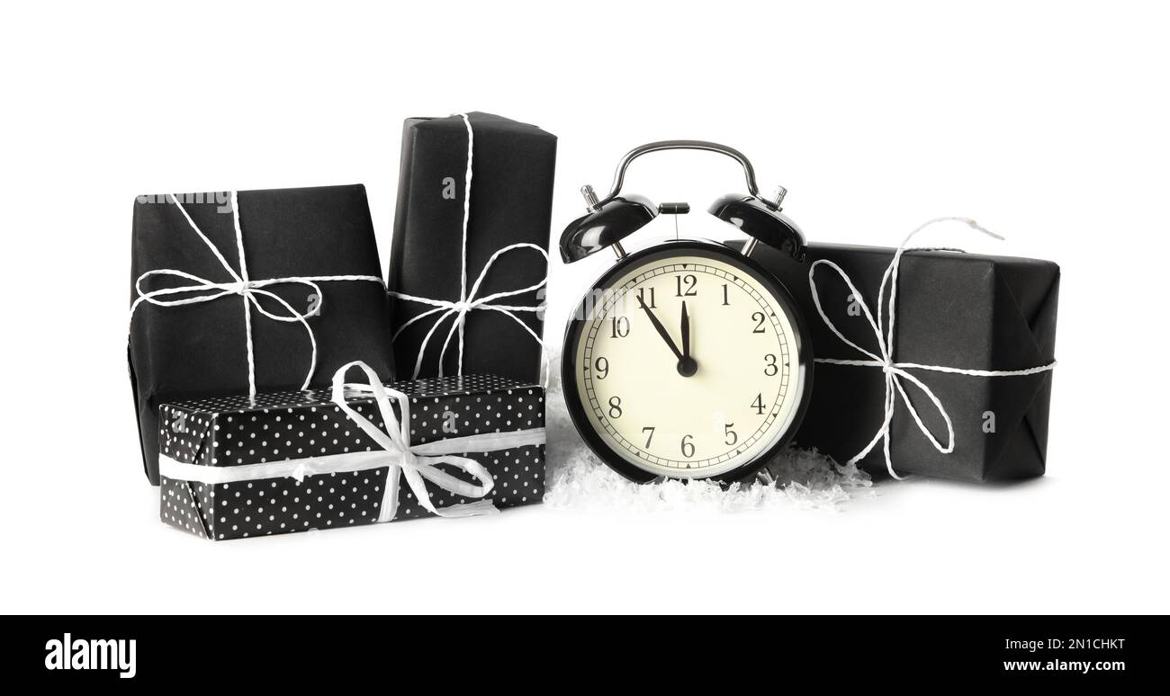 Alarm clock and gifts on white background. New Year countdown Stock ...