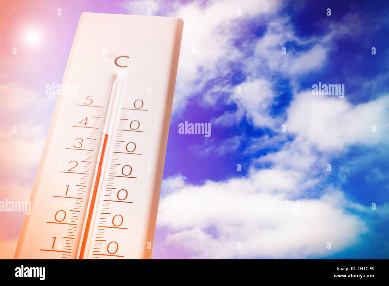 Weather thermometer showing high temperature and blue sky with clouds ...