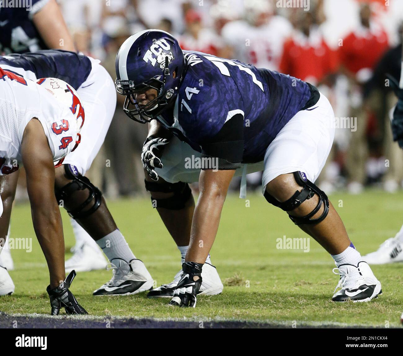 TCU offensive tackle Halapoulivaati Vaitai (74) lines up at the line of ...