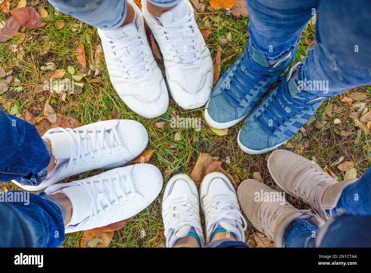 Legs of people in sneakers. The family walks in a circle. Team building ...