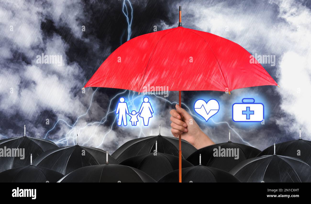 Insurance agent covering illustrations with red umbrella during storm ...