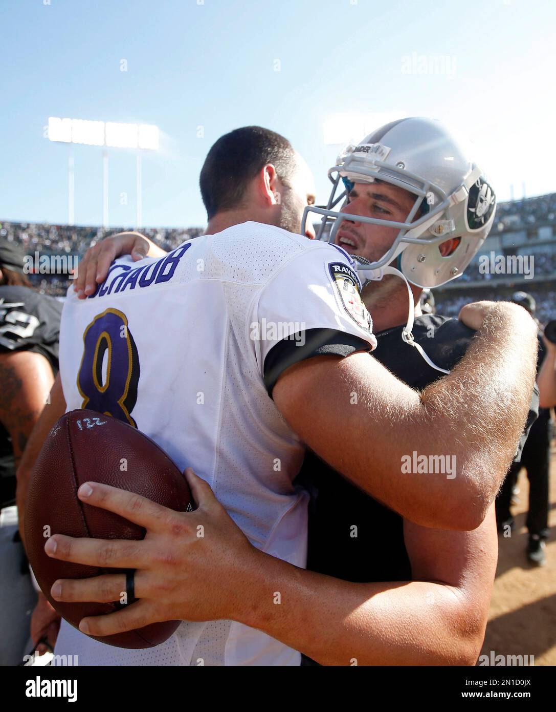Oakland Raiders quarterback Derek Carr, right, hugs Baltimore Ravens ...