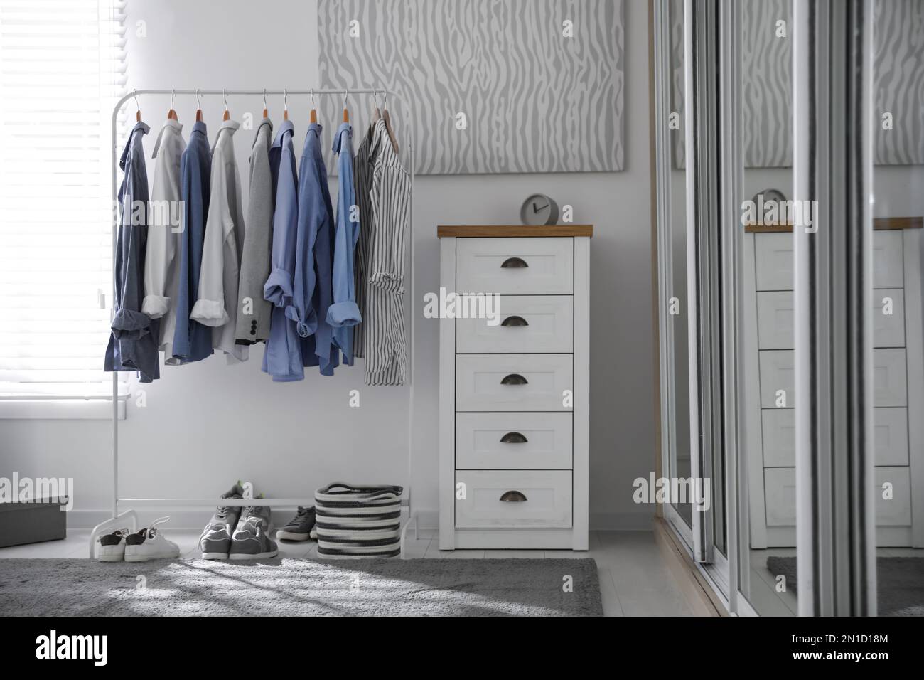 Dressing room interior with clothing rack and chest of drawers Stock ...