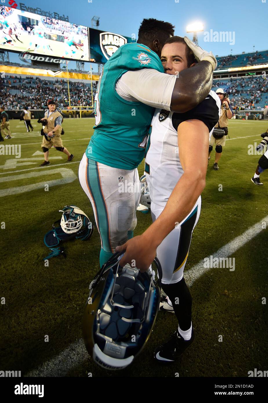 Miami Dolphins defensive end Terrence Fede (78) embraces Jacksonville ...