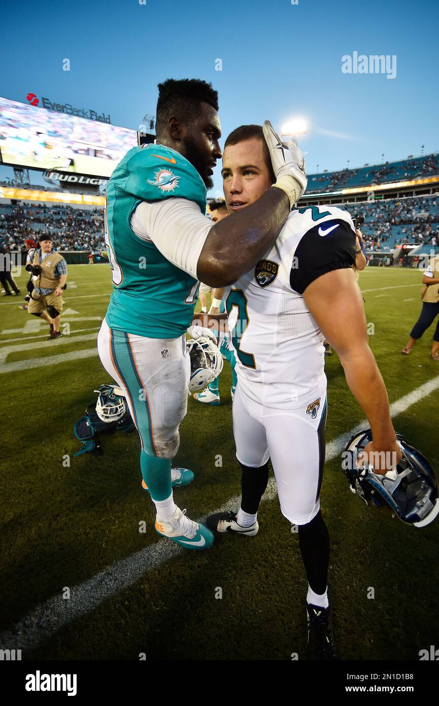 Miami Dolphins defensive end Terrence Fede (78) embraces Jacksonville ...