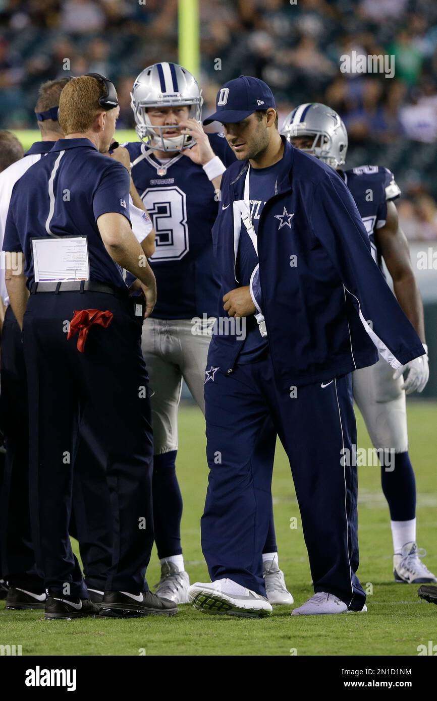 Injured Dallas Cowboys quarterback Tony Romo, center, walks with team ...