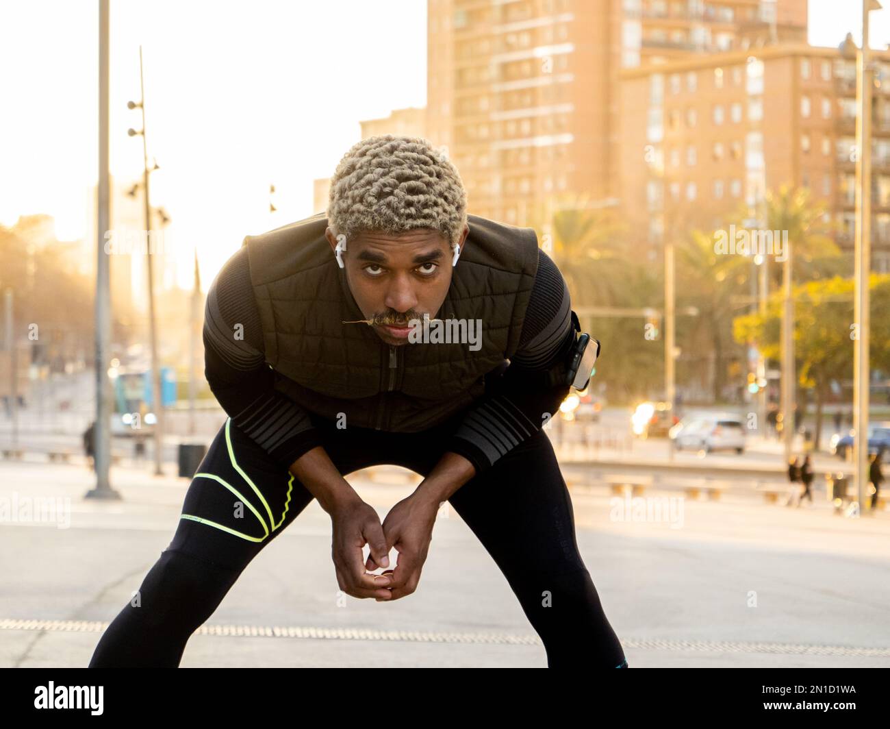 Exhausted african american male runner with mustache breathes deep ...