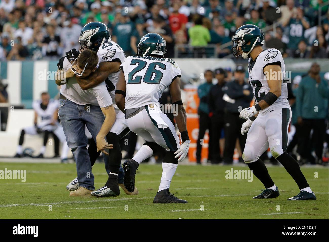 Philadelphia Eagles' Nolan Carroll (23) tackles a fan that ran onto the ...